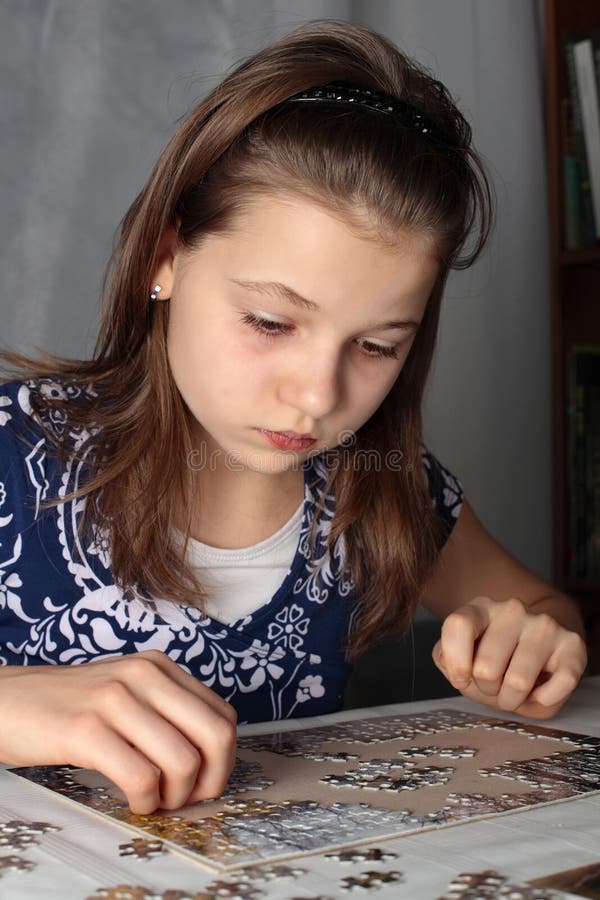 Teenage girl doing puzzle stock photo. Image of teenage - 16763964