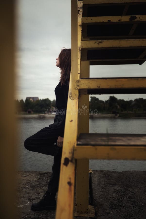 A Teenage Girl Stands Alone on the Pier at the Pier Trying To Cope with ... A Teenage Girl Stands Alone on the Pier at the Pier Trying To Cope with ...