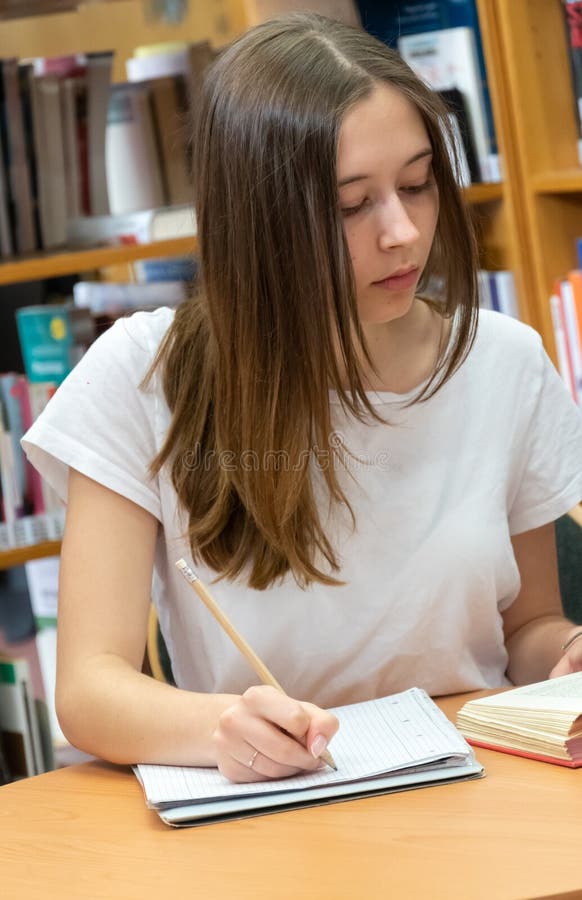 Teenage Girl Studying in a Library Stock Photo - Image of notebook ...