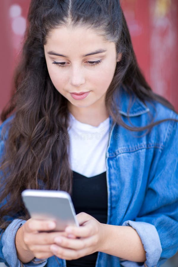 Teenage Girl Texting on Mobile Phone in Urban Setting Stock Photo ... Teenage Girl Texting on Mobile Phone in Urban Setting Stock Photo ...