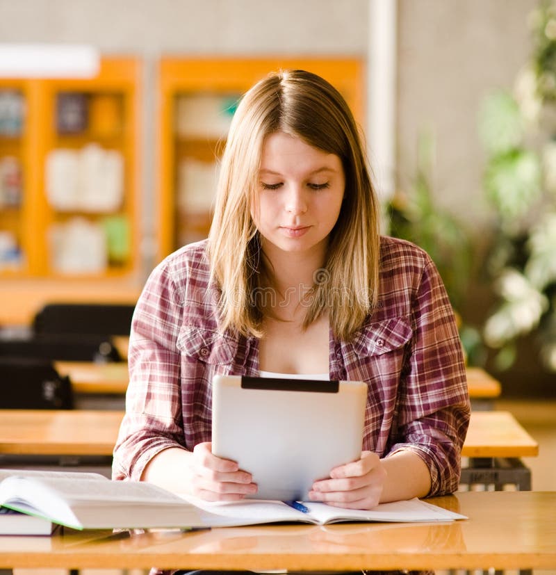 Teenage Girl Using Electronic Tablet Library Stock Photos - Free ...