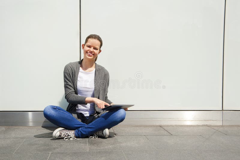 Teenage Laughing while Look at Ipad by the Glass Wall Stock Photo ...