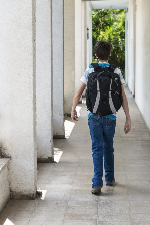 Teenage School Boy with a Backpack on His Back Walking To School Stock ...