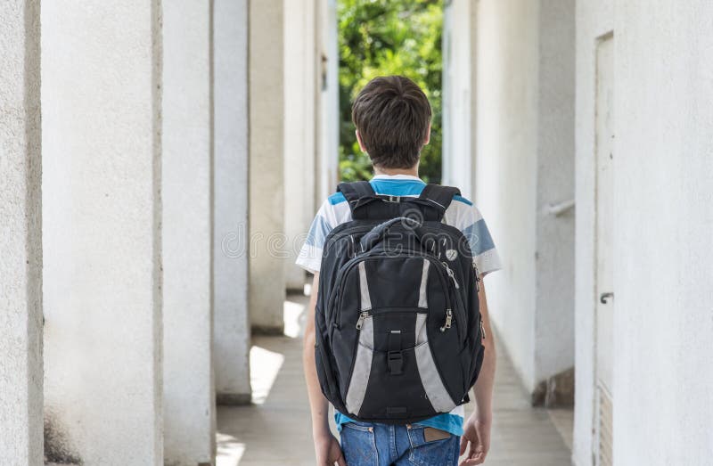 Teenage School Boy with a Backpack on His Back Walking To School Stock ...