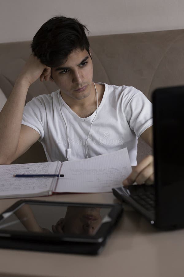 Teenage Student Studying at Home Using His Tablet and Computer Stock ...