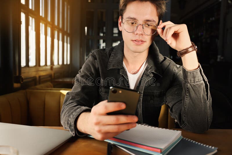 Teenage Student Using Smartphone while Studying in Cafe Stock Image ...