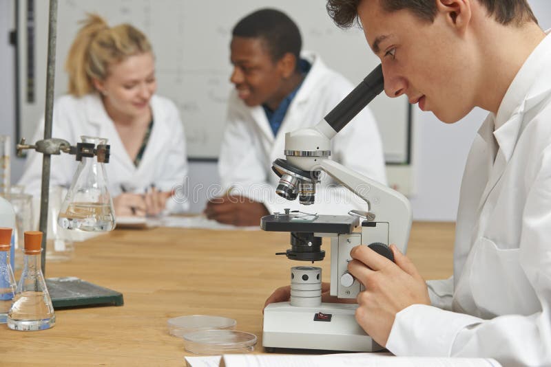 Teenage Students in Science Class Using Microscope Stock Photo - Image ...