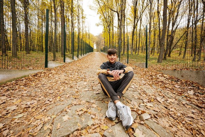 Teenager Boy Sit on Path at Autumn Fall Forest Stock Photo - Image of ...
