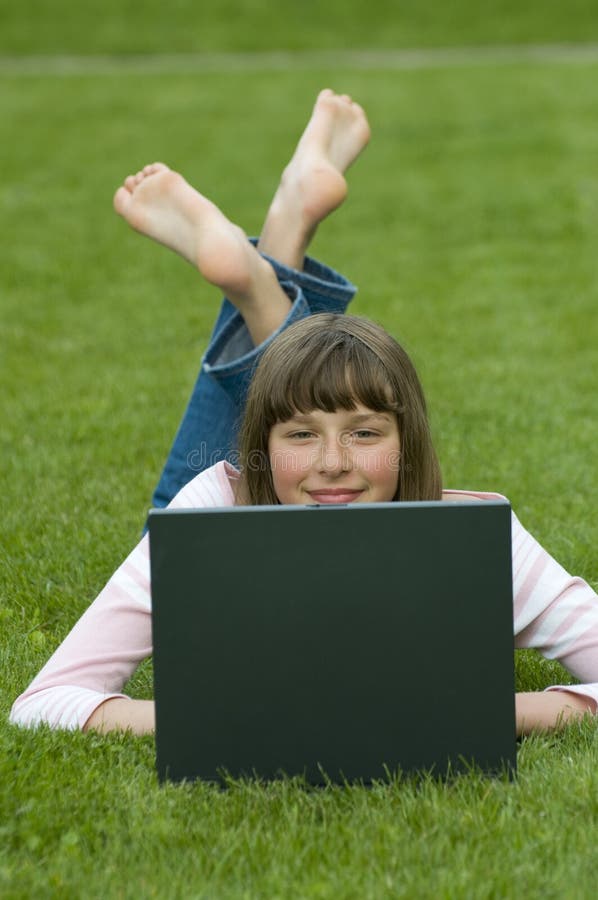 Teenager with Computer on the Grass Stock Photo - Image of technology ...