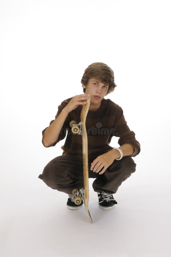 Teenager Crouching Down with Skateboard Stock Image - Image of person ...