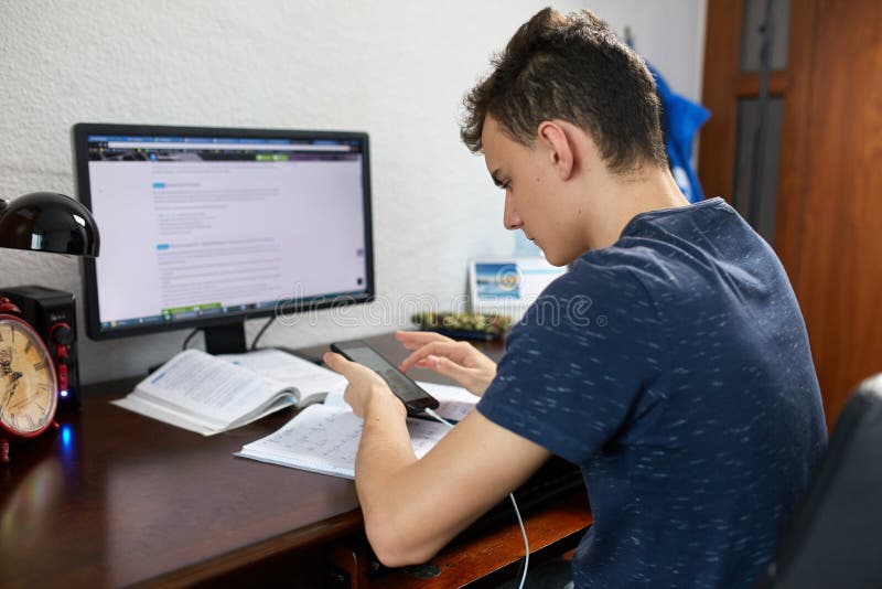 Teenager Doing Homework with Computer Stock Photo - Image of male, exam ...