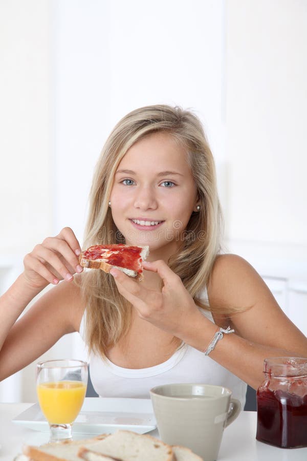 Teenager Eating Slice of Bread Stock Photo - Image of teen, breakfast ...