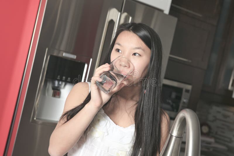 Teenager Girl Drinking Water in the Kitchen Stock Photo - Image of ...