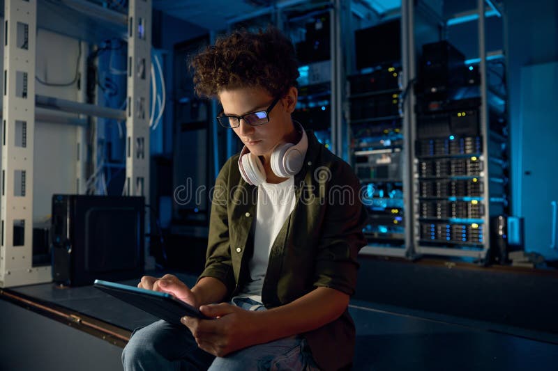 Teenager Guy it Technician Working on Tablet Inside Server Room Stock ...