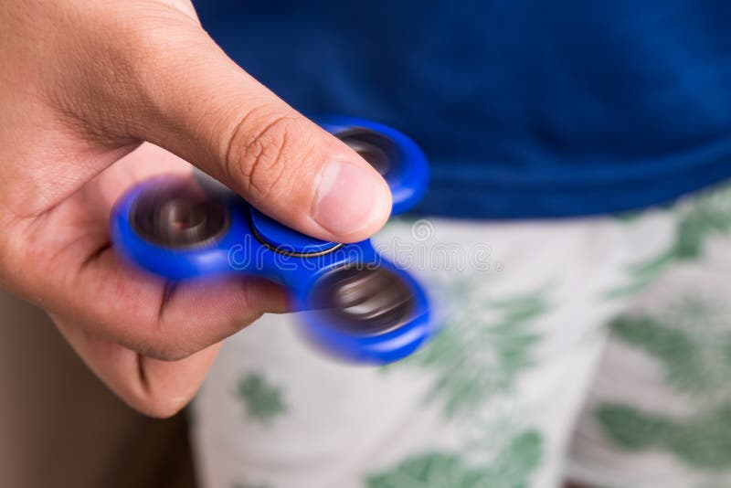 Teenager Holding a Spinning Fidget Spinner Stock Image - Image of ...
