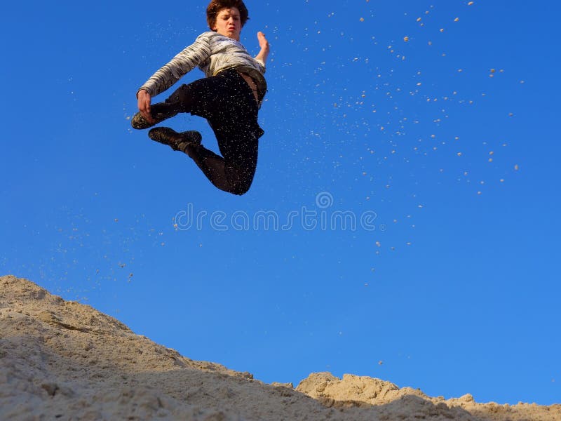 Teenager Jumps from Sand Hill Stock Photo - Image of jump, danger: 3338610