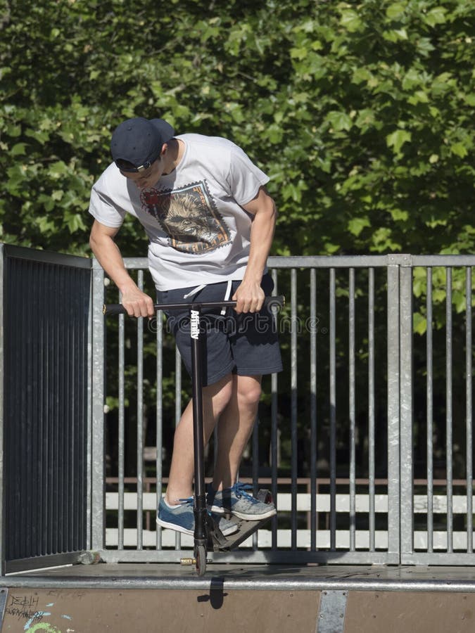 Teenager with a scooter editorial photography. Image of child - 93009912