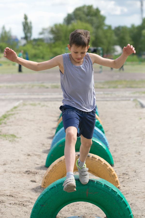 A Teenager in a T-shirt is Engaged on the Obstacle Course Stock Photo ...