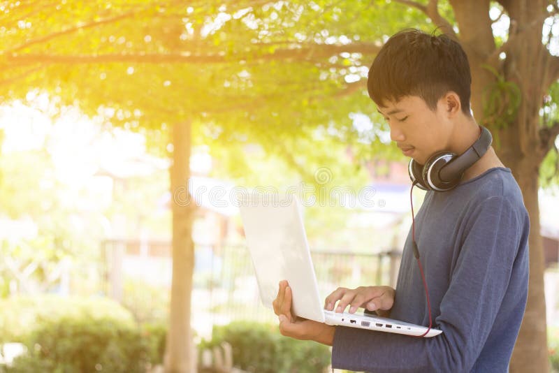 Teenager using laptop stock photo. Image of asian, wireless - 90104366
