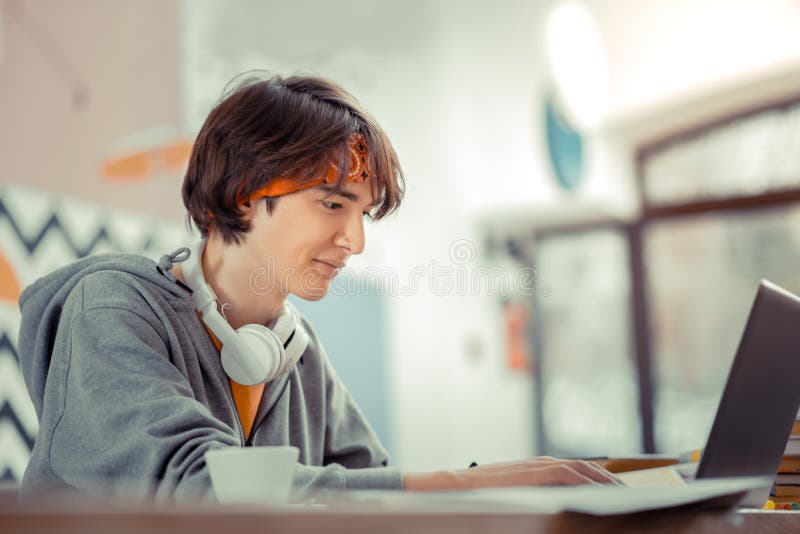 Teenager Working with the Computer while Sitting in the Cafe Stock ...