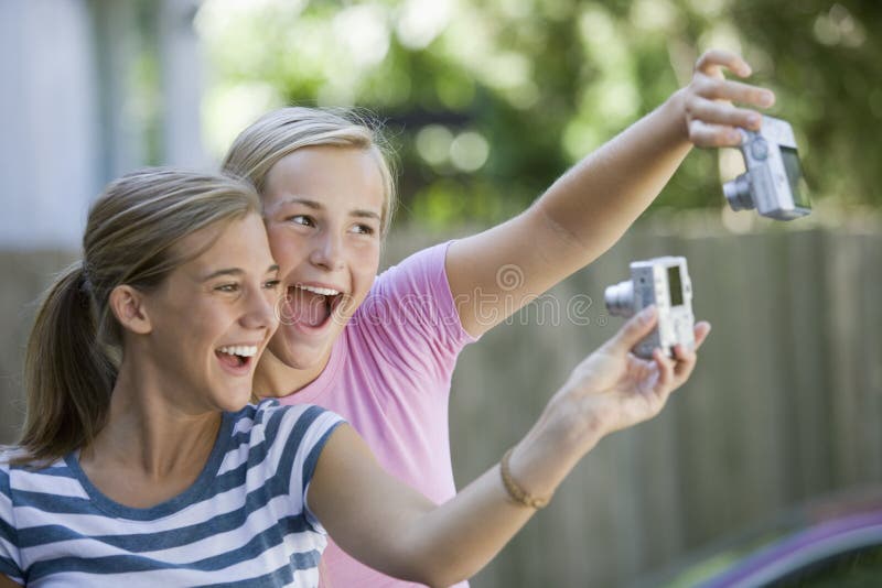 Teenagers with cameras stock image. Image of interaction - 5231409