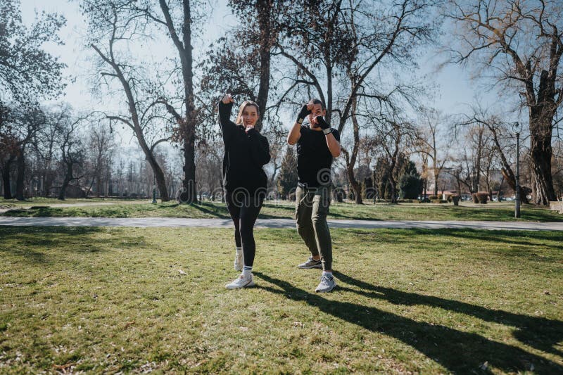Teenagers Engaging in an Outdoor Boxing Workout within a Scenic Park ...
