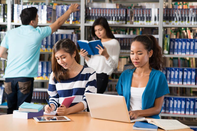 Teenagers in library stock photo. Image of adolescent - 36778030