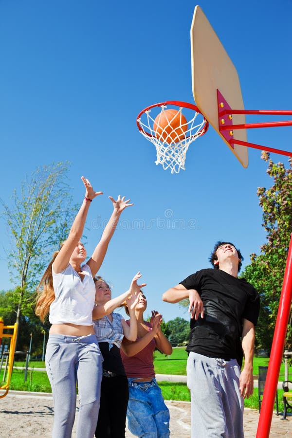 Teenagers Playing Basketball Stock Image - Image of jump, friendship ...