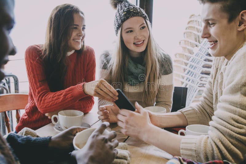 Teenagers Socialising in a Winter Cafe Stock Photo - Image of adult ...
