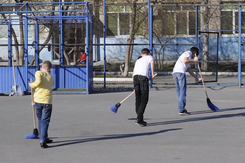 Teenagers Sweep the Yard with Sweepers during a Community Work D ...