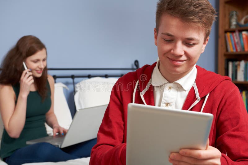 Teenagers Using Digital Technology at Home Stock Photo - Image of ...