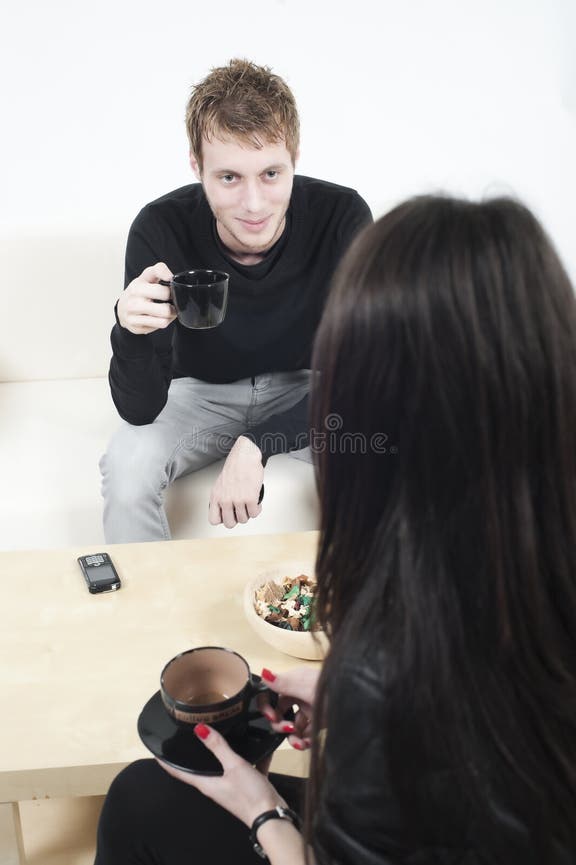 Teens sharing coffee time stock image. Image of home - 17918651