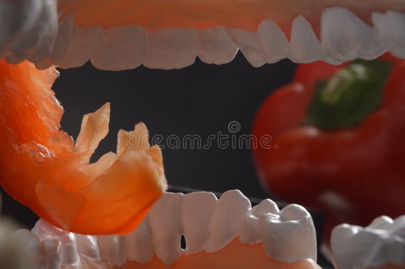 Teeth Biting Down on Red Pepper Stock Photo - Image of vegetable, mouth ...
