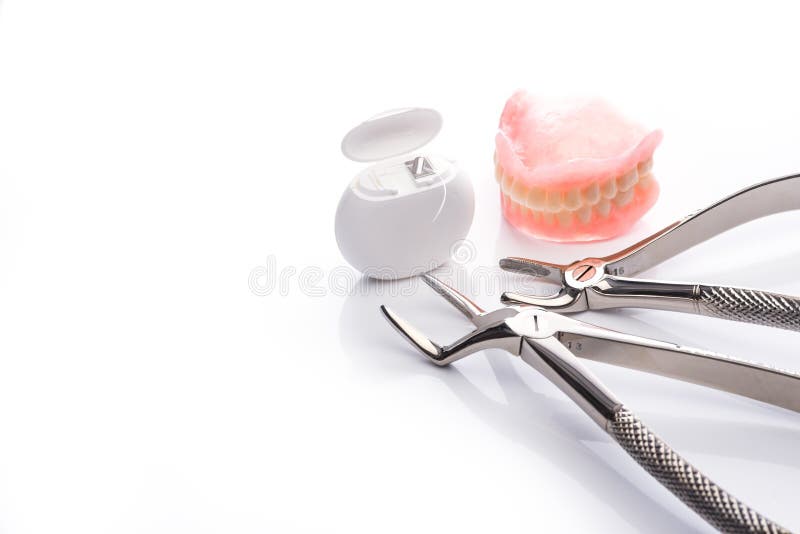 Teeth Model with Dental Floss and Forceps on White Background Stock ...