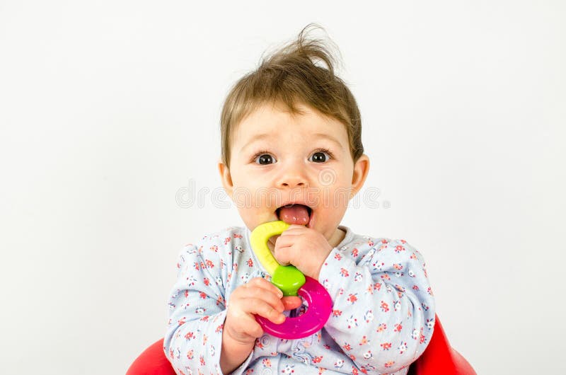 Teething baby girl stock image. Image of funky, colorful - 76370791