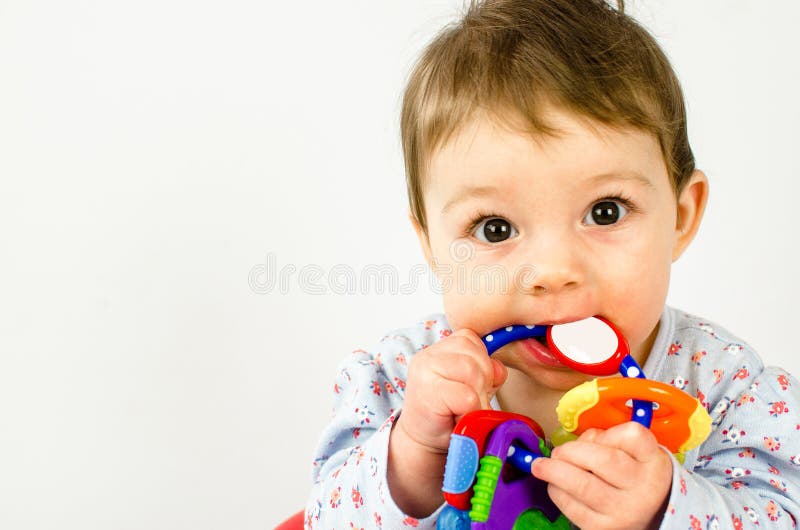 Teething baby girl stock photo. Image of cheerful, colorful - 76375800