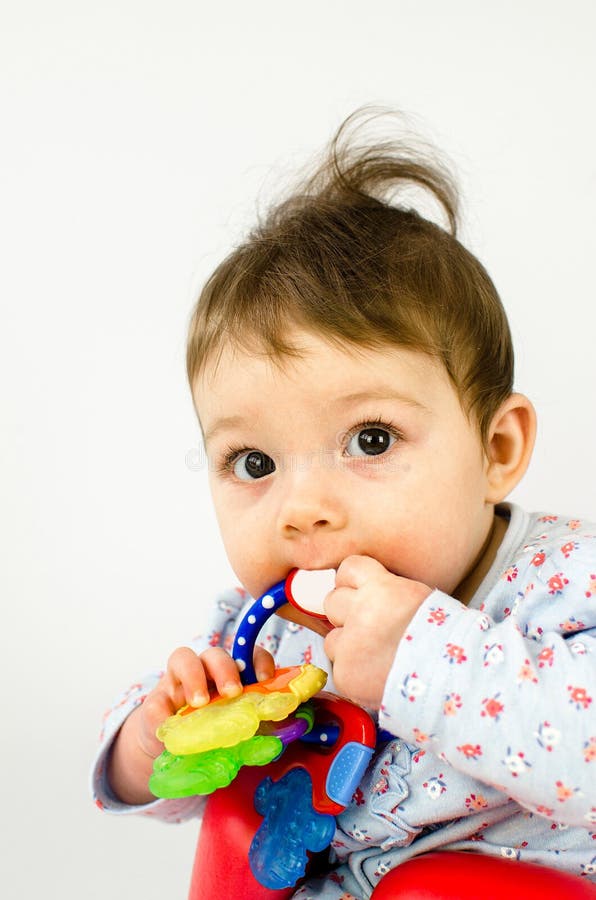 Teething baby girl stock image. Image of funny, siting - 76375809