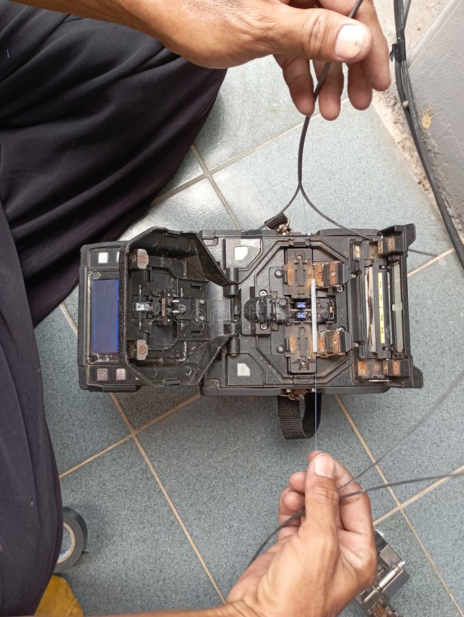 Telecom Officer is Connecting Broken Fiber Optic Cable Stock Photo ...