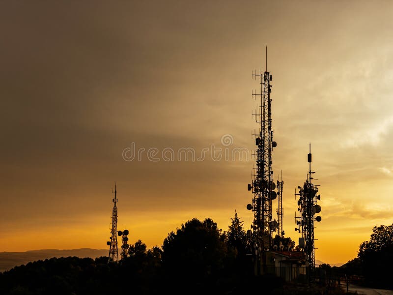 Telecommunication Antenna Towers with Sunset on Background. Stock Photo ...