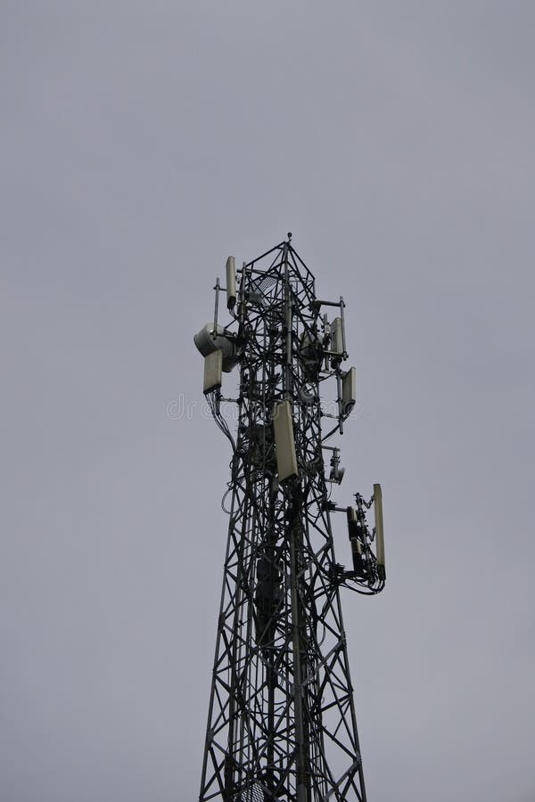 Telecommunication Tower Reaching Skyward Under Cloudy Sky Stock Photo ...