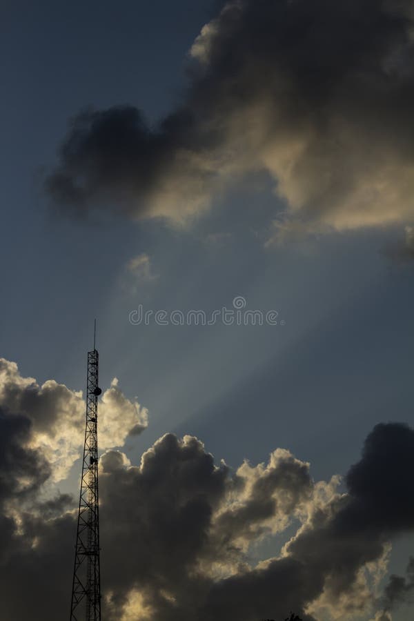 Telecommunications Antenna Surrounded by Storm Clouds and Sun Rays ...
