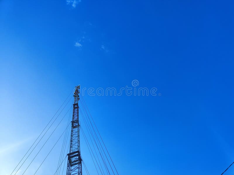Telecommunications Tower with a Blue Sky Background Stock Image - Image ...