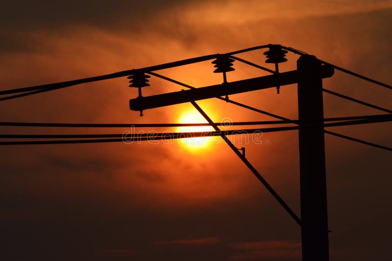 Telegraph Pole Sunrise, High voltage poles on background of sun