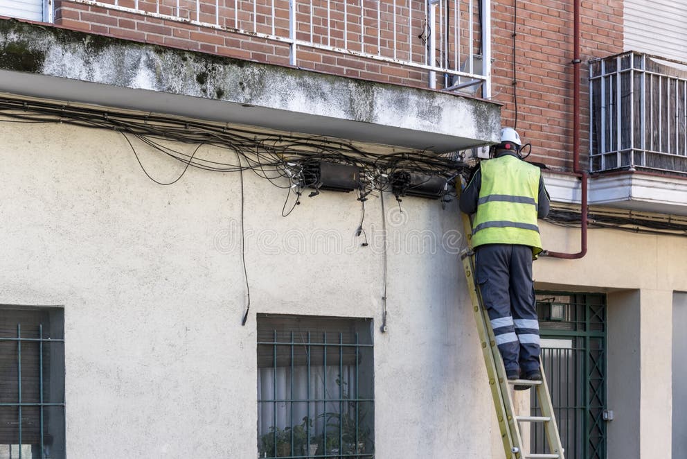 A Telephone Company Worker Working on a Ladder Stock Photo - Image of ...