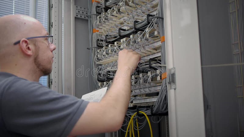 A Telephone Engineer Checks the Routing of Telephone Outlets Stock ...