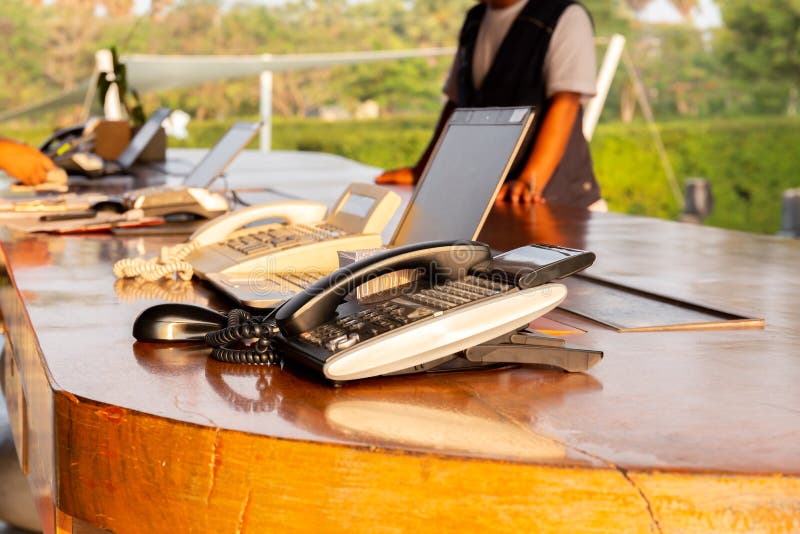 Telephone on Hotel Reception Desk with Customer Check in at Reception ...