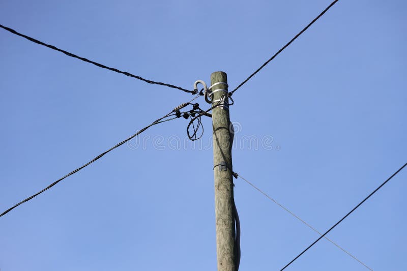 A Telephone Pole with Wires Against a Clear Blue Sky Stock Photo ...