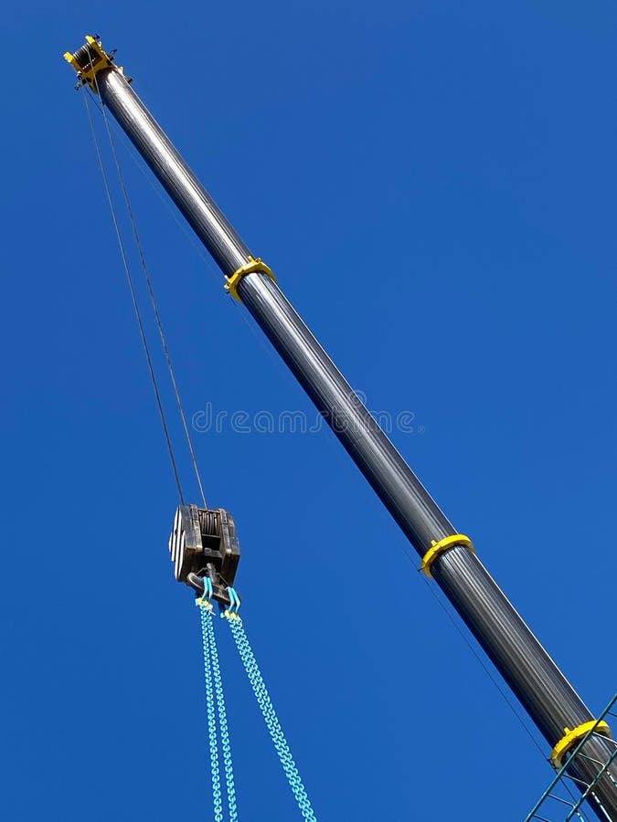 Telescopic Crane at a Construction Site Under a Blue Sky, a Vertical ...