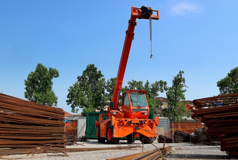 A Telescopic Handler Loader among Steel Bars in a Construction Site ...