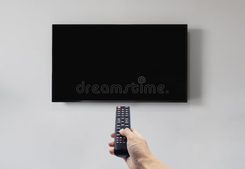 Television on White Wall with Hand Using Remote Control, Blank Black ...